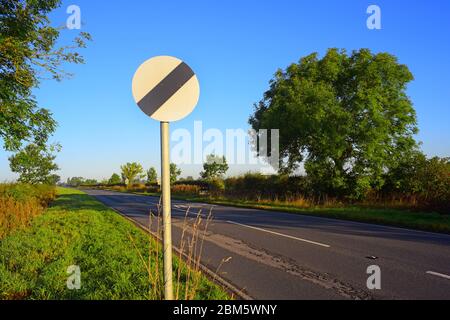 cars passing derestricted roadside speed limit warning sign united ...
