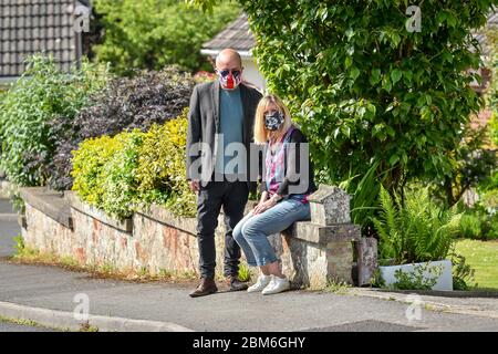 Residents wearing face masks chat each others outside a hotel in ...