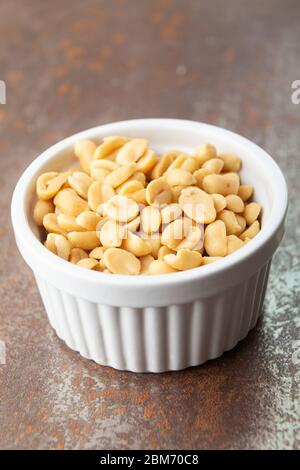 raw peanuts in white bowl isolated on black background healthy snack ...