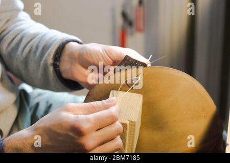 Handmade handicraft leather bag sewing process. Glue working with ...