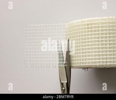 The Sticky yellow mesh tape Stock Photo - Alamy