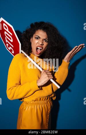 Image of attractive displeased woman with curly red hair showing finger ...