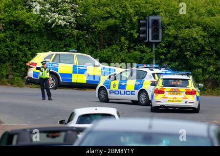 Police vehicles used as a road block, to divert traffic away from an ...