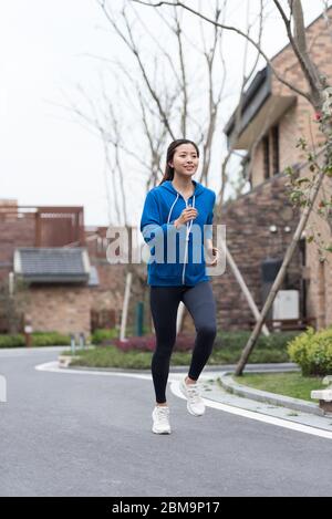 Healthy Asian woman is jogging outdoor. Fitness girl running. Female ...