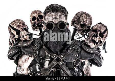 Evil creature wearing tattered rags and gas mask, holding a blood ...