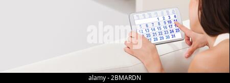 Menstruation. Woman using period calendar application on smartphone at ...