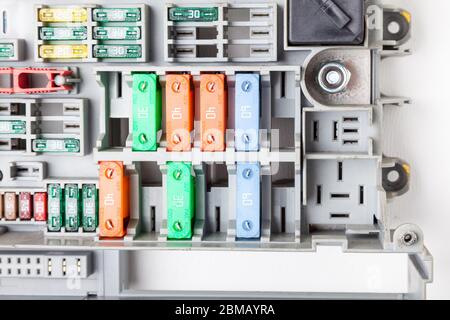 Plastic fuse box inside the engine compartment, visible fuses, relays ...