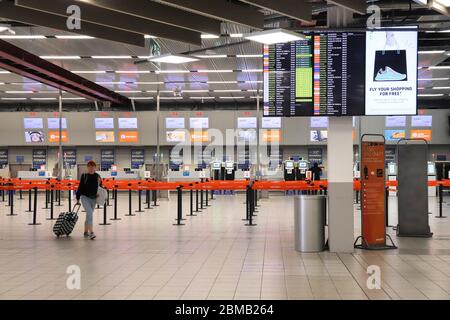 London Luton Airport, UK, check-in hall. Easyjet passengers queue to ...