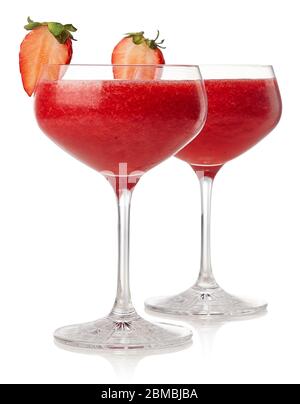 Two glasses of sweet strawberry frozen cocktails with mint garnish on a ...