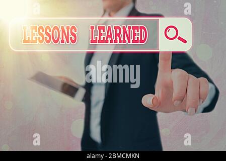 Writing note showing Lessons Learned. Business concept for the knowledge or understanding gained ...