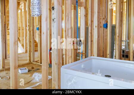 Interior framing of bathroom a new acrylic bathtub with a wood frame ...