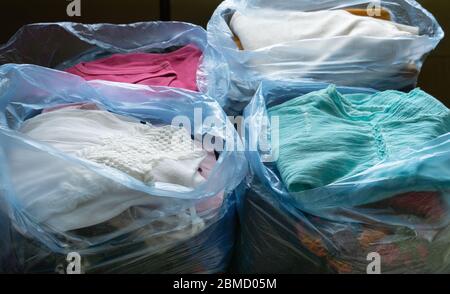 many vintage used clothes in the flea market Stock Photo - Alamy