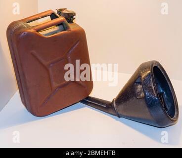 Green metal canister on light grey background, closeup. Space for text ...