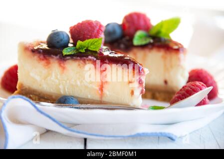 Delicious fresh raspberry cheesecake on wooden table Stock Photo - Alamy