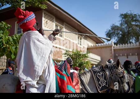 Musician playing traditional Nigerian trumpet during the celebration of ...