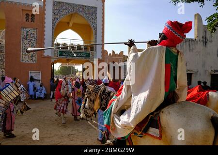 Musician playing traditional Nigerian trumpet during the celebration of ...