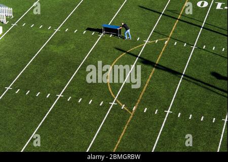 Man pushing table across football field Stock Photo - Alamy