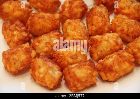 Fried and crispy tator tots on a white plate Stock Photo - Alamy