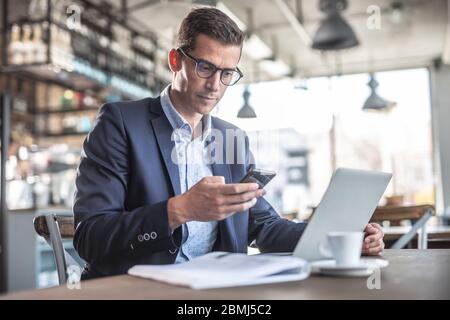Handsome man holds a notebook and coffee, surrounded by a vibrant ...
