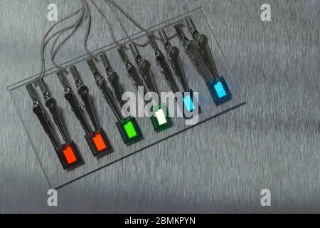 Several Red Green color oled displays is lighting on a probecard. Grey ...