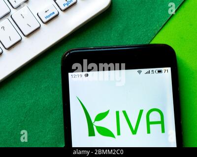 In this photo illustration, the Kiva logo is seen displayed on a ...