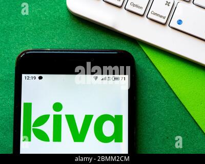 In this photo illustration, the Kiva logo is seen displayed on a ...