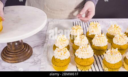 Arranging pumpkin spice cupcake decorated with Italian buttercream ...