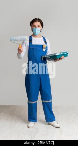 Hands of worker painting wall in room Stock Photo - Alamy