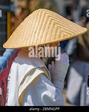 Female monk in Kyoto, Japan. Holding shakujo staff, wearing a gasa ...