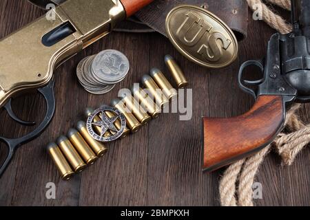 Wild west weapons, ammunition and Texas Rangers star badge with silver ...