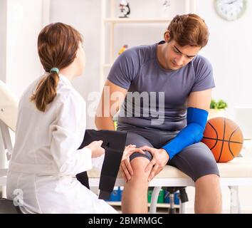 Handsome basketball player visiting female doctor traumatologist Stock ...