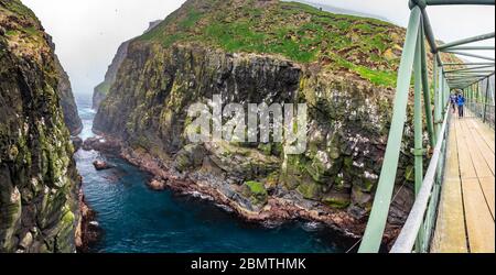 Suspension bridge in Mykines island connecting islands Stock Photo - Alamy