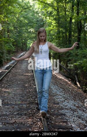 Lovely Blond woman on railroad tracks Stock Photo - Alamy