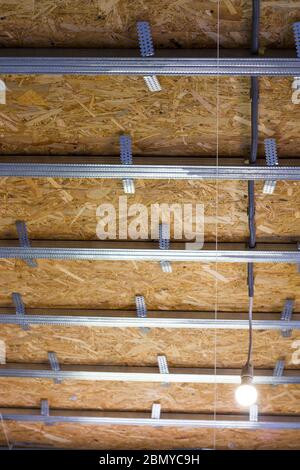 Unfinished ceiling skeleton installation. Drywall mounting profile on ...
