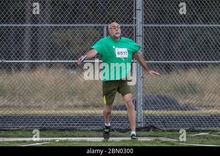 Men's discus throw, age group 55 years old. Getting set to release ...