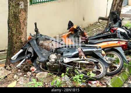 A rusty half-destroyed bike is lying on the lawn. Landfill of old ...
