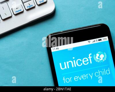 In this photo illustration the UNICEF logo seen displayed on a ...