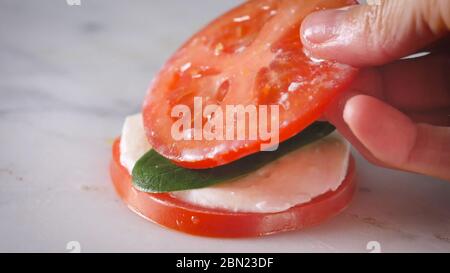 Preparing sandwich, tower caprese salad. Healthy vegetarian salad with ...