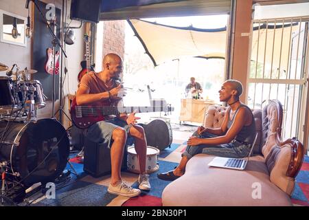 Musicians talking and practicing in recording studio Stock Photo - Alamy