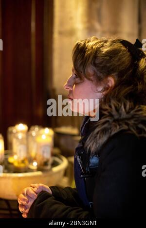 Catholic convert praying in a church in Paris, France Stock Photo - Alamy