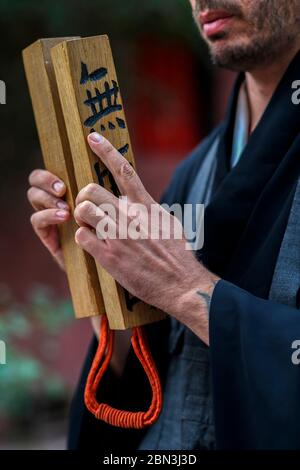 Zen monk sounding clappers in Morocco Stock Photo - Alamy