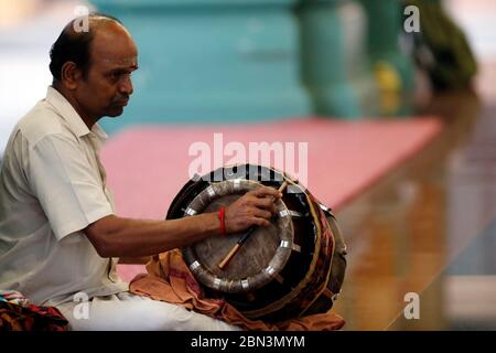 Sri Mahamariamman Hindu Temple. Musician playing a Thavil, a tradional ...