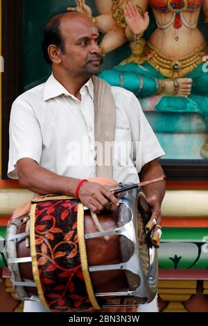 Sri Mahamariamman Hindu Temple. Musician playing a Thavil, a tradional ...
