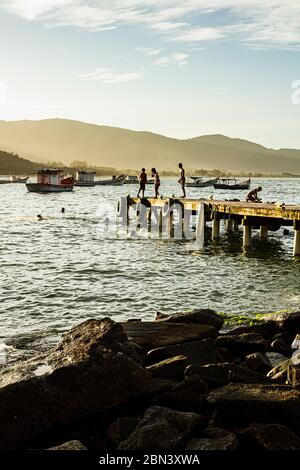 People on a pier at Armacao Beach. Florianopolis, Santa Catarina ...
