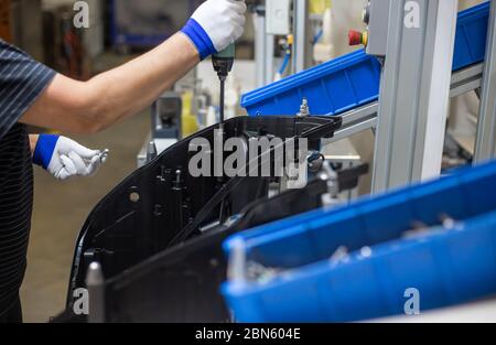 Production operator assembling frontlight headlamp, headlight for a ...