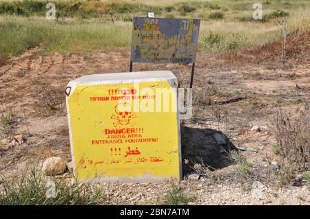 A warning sign at the entrance to a military shooting range ...