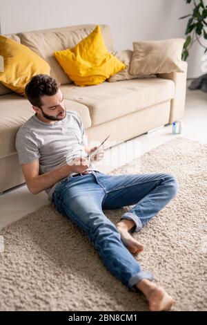 Young handsome man holding covid record card smiling happy and positive ...