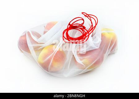 String bag with red ripe apples on white background. Top view Stock ...