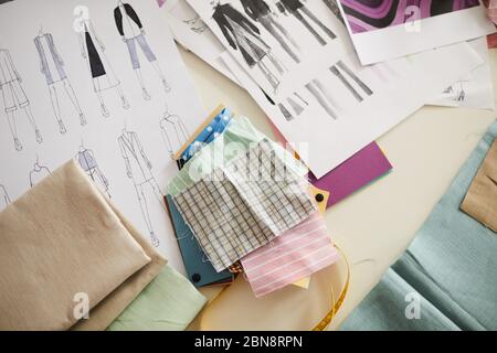 Sketches of clothes and fabric samples on table Stock Photo - Alamy
