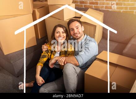 Happy couple have to move and arrange all the packages. Concept of ...